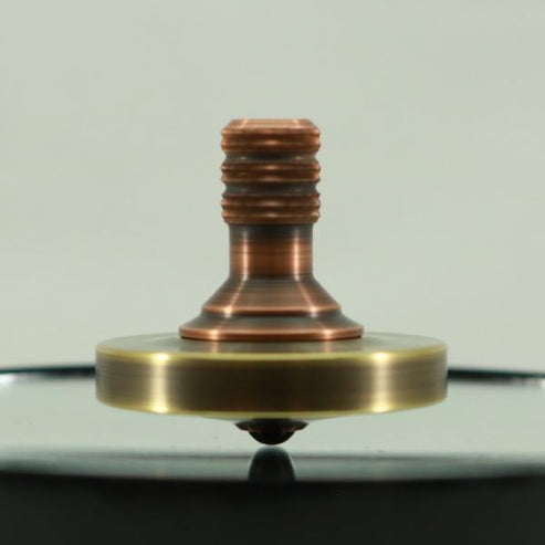 Precision metal spinning top in antique brass and copper – Kemner Design